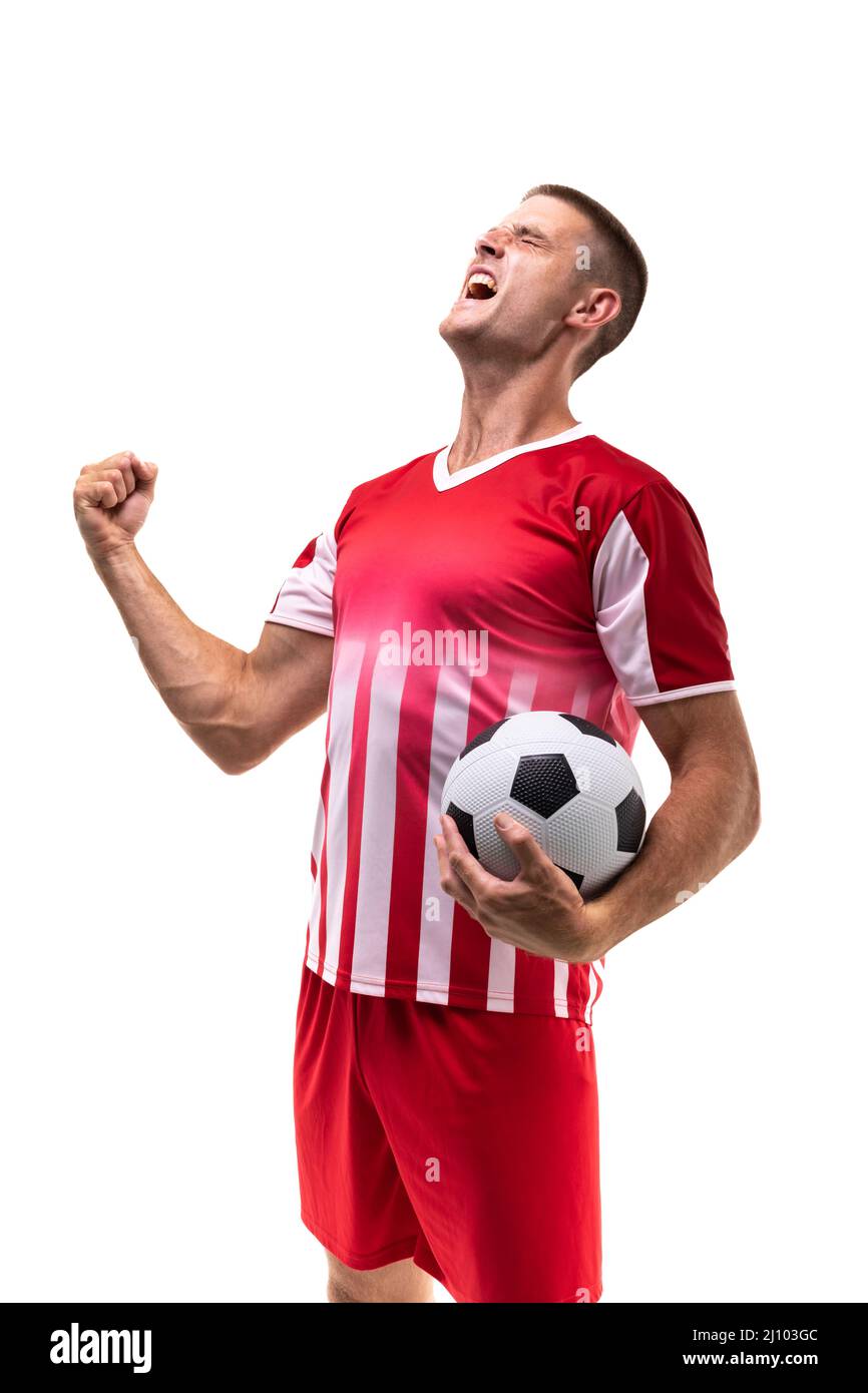 Excited young caucasian male soccer player shouting after scoring goal ...