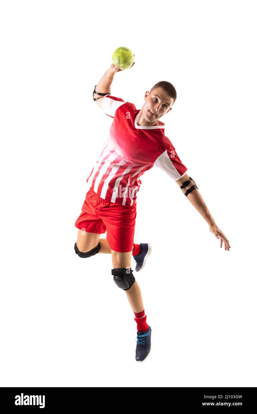 Confident young male caucasian handball athlete throwing ball against ...