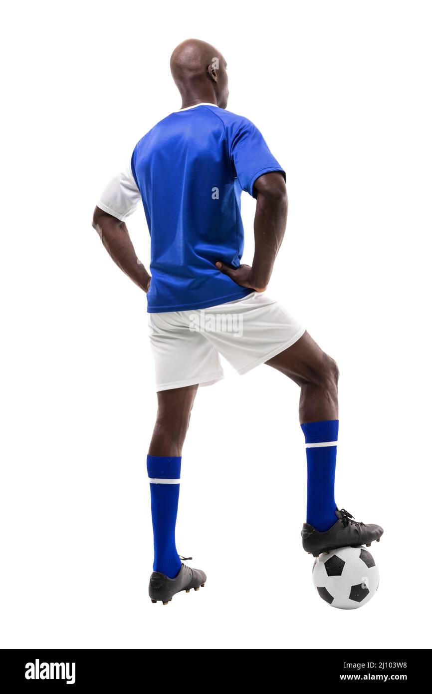 Rear view of young male african american soccer player stepping on ball ...