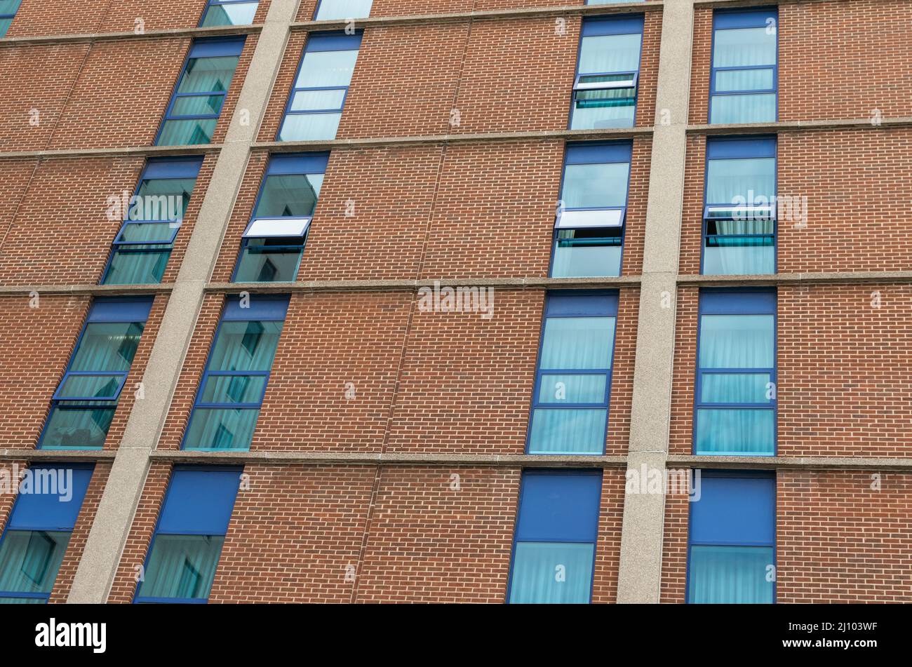 blue windows in red brick building Stock Photo - Alamy
