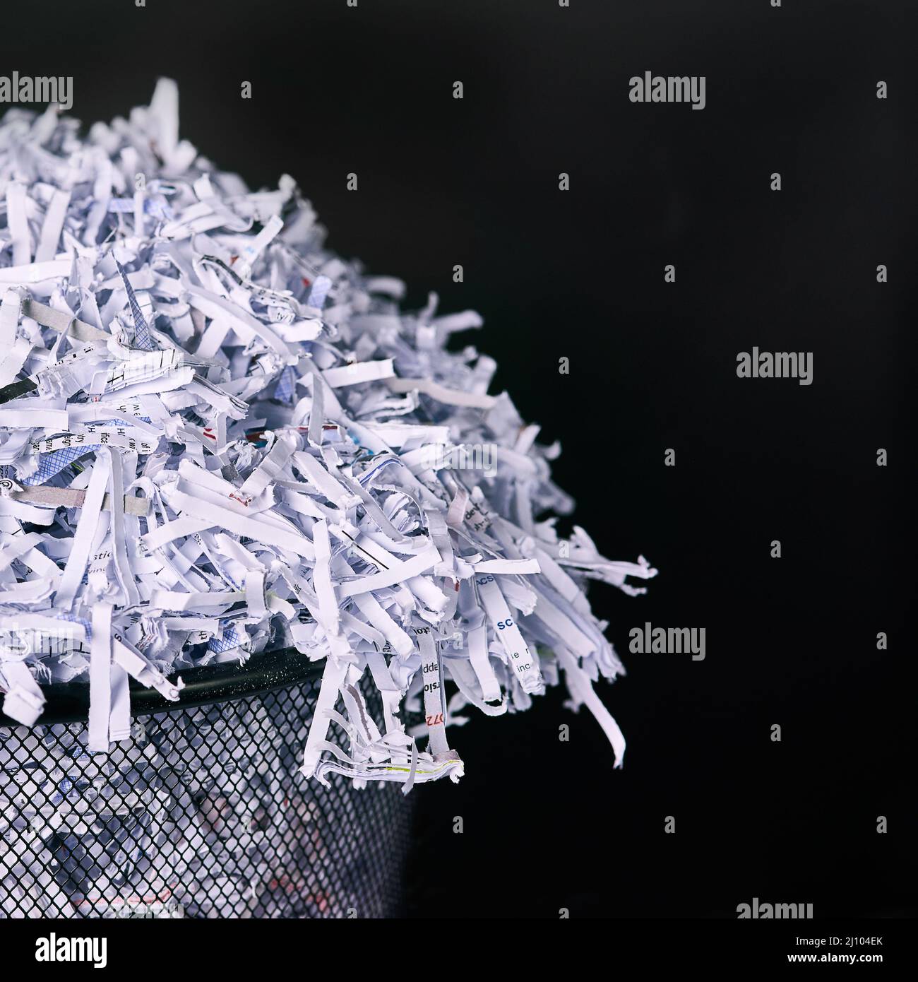 Leaving no paper trail. Studio shot of shredded paper in a dustbin ...