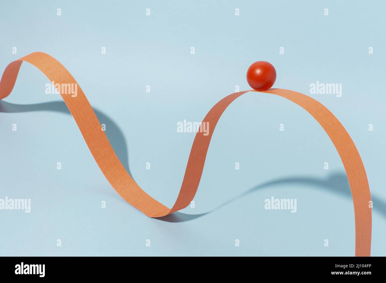 Orange ribbon with ball Stock Photo - Alamy