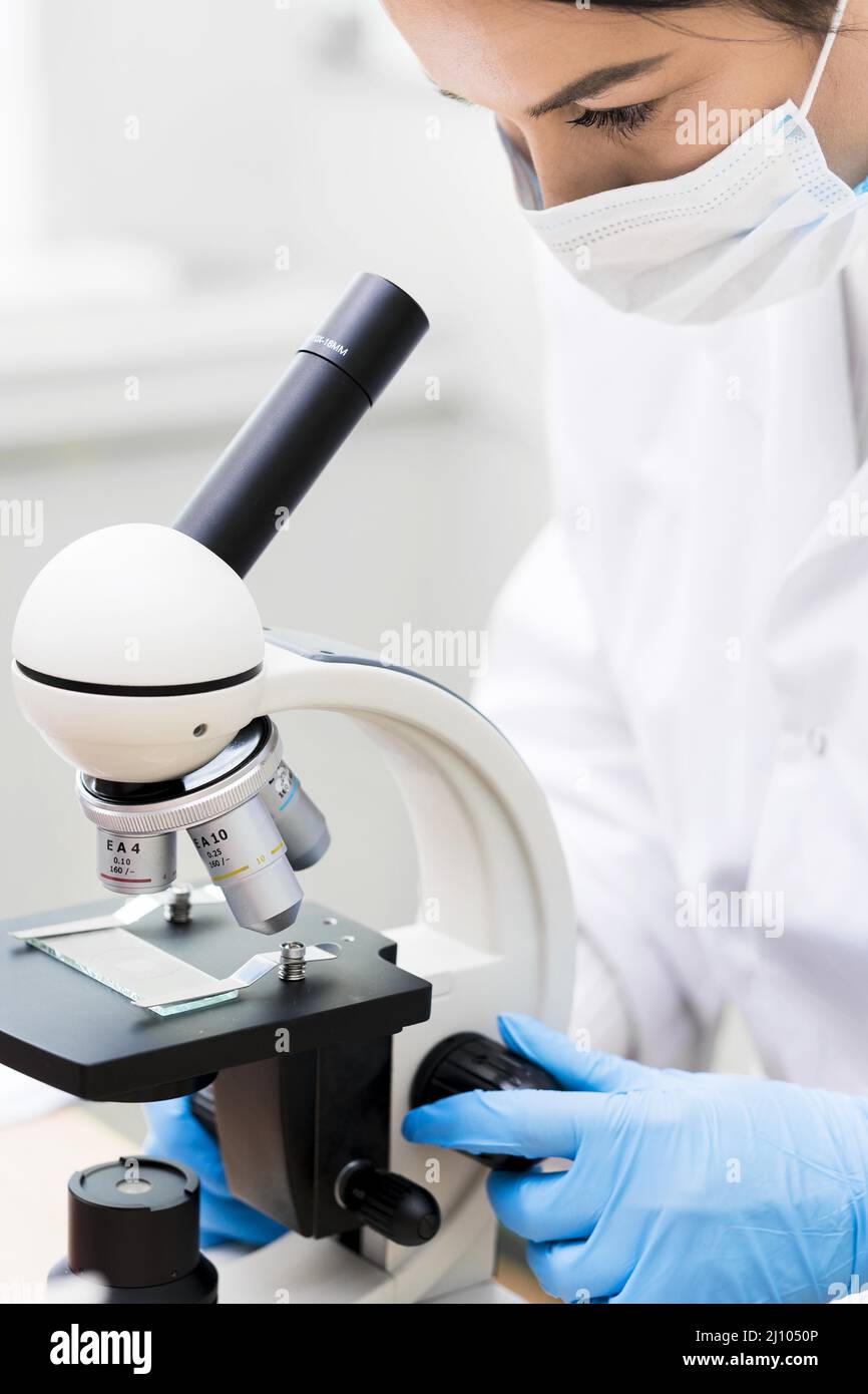Woman with mask microscope Stock Photo - Alamy