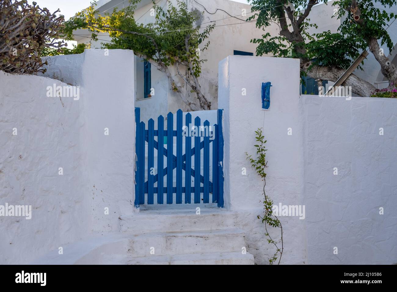 Greek Island, Cyclades. Blue wooden fence entrance gate close ...
