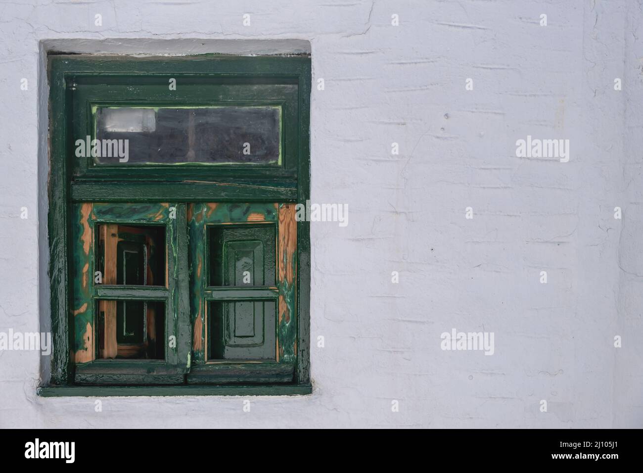 Greek Island, Greece. Green wooden shabby window, aged whitewashed ...