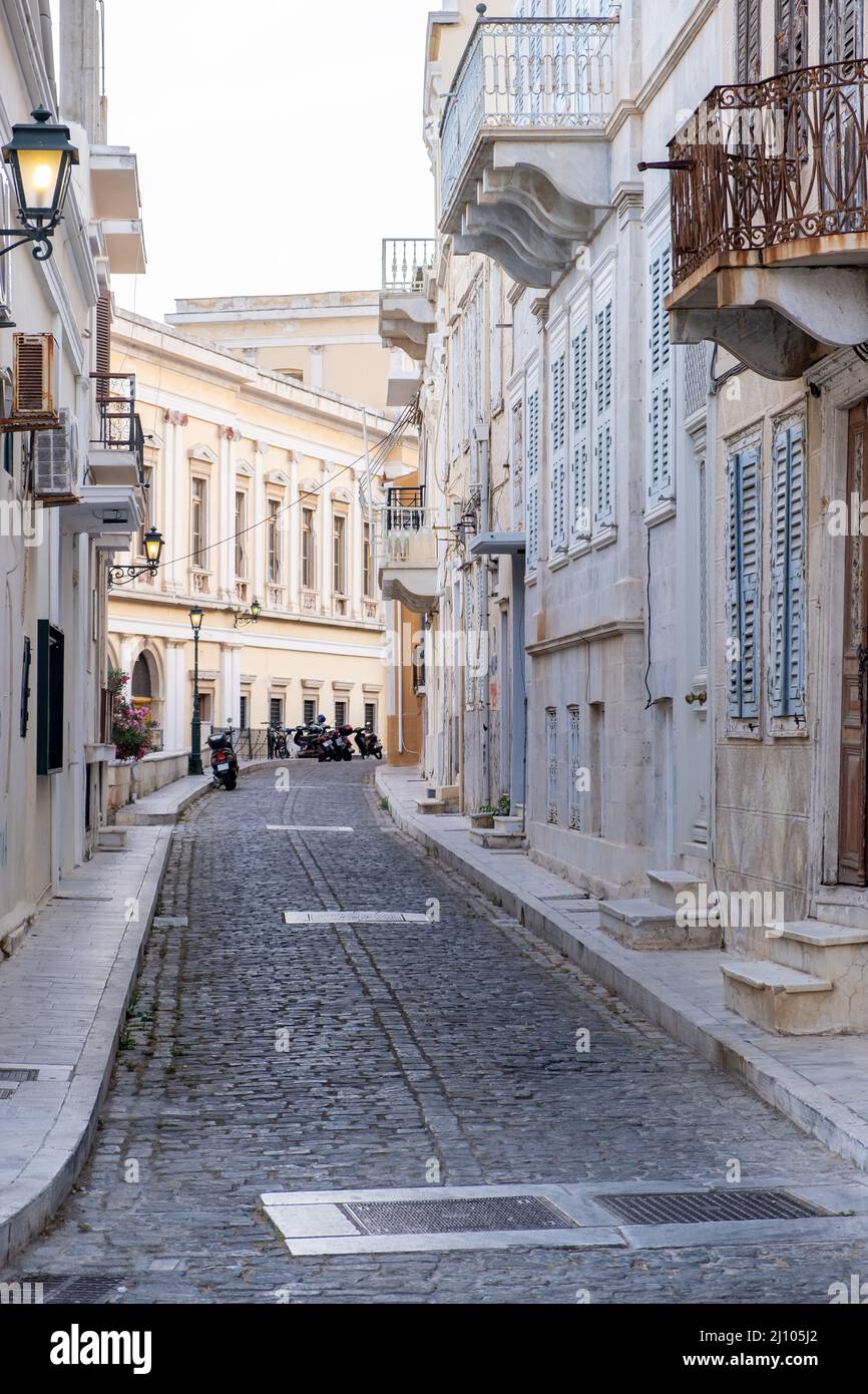 Neoclassical building and empty cobblestone street at Syros island ...