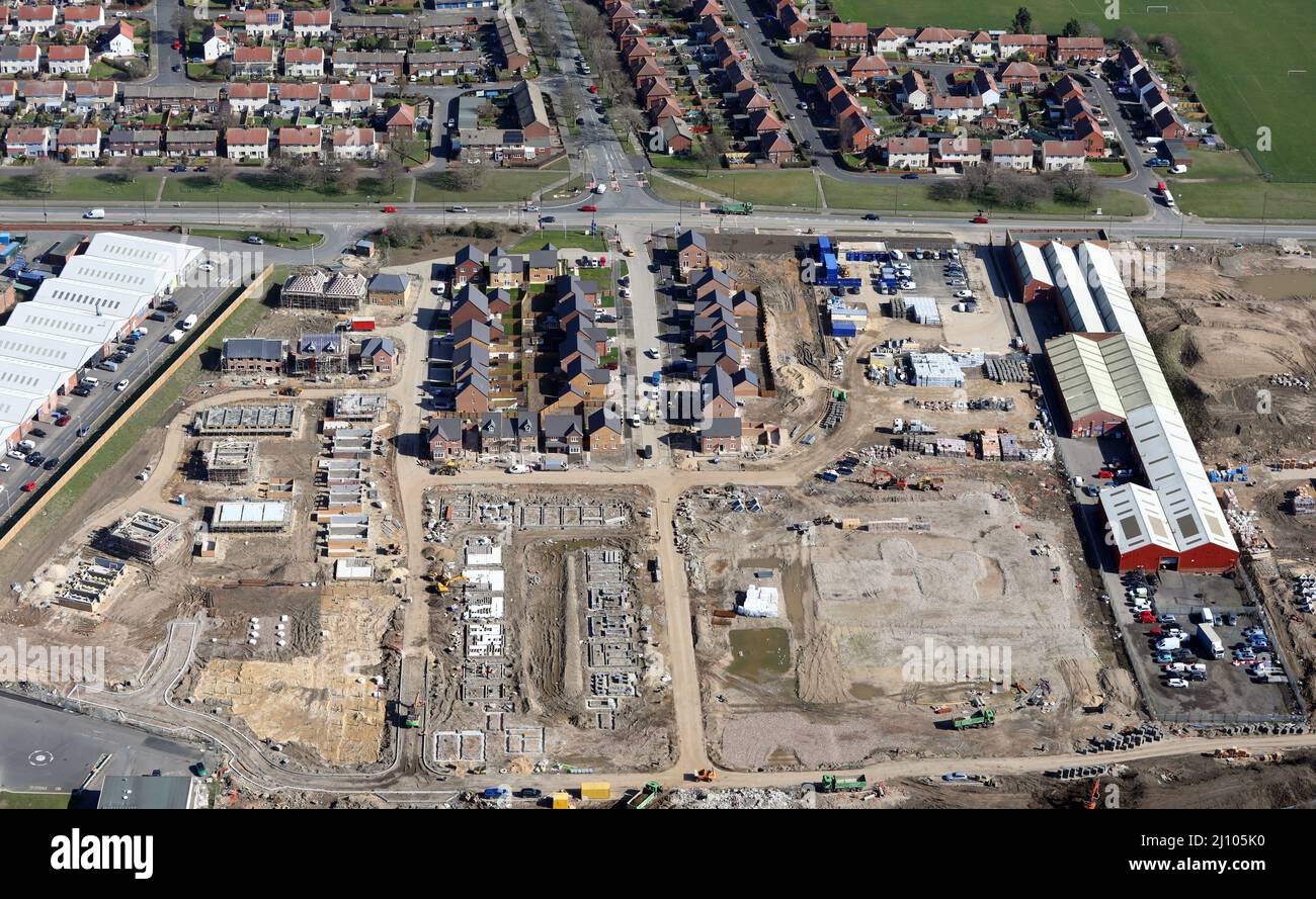 aerial view of a new housing development being built on a brown field ...