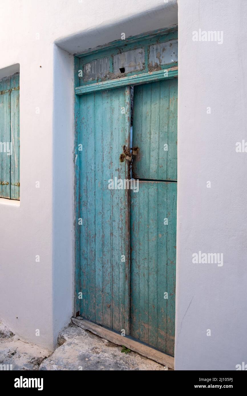 Blue door wooden faded vintage locked with chain and padlock, weathered ...