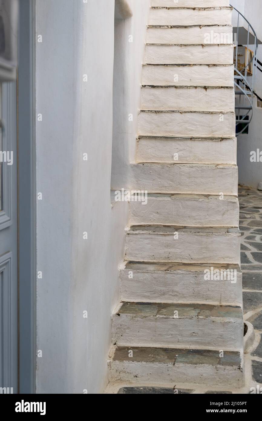 Whitewashed building stone stair going up to the roof, narrow ...
