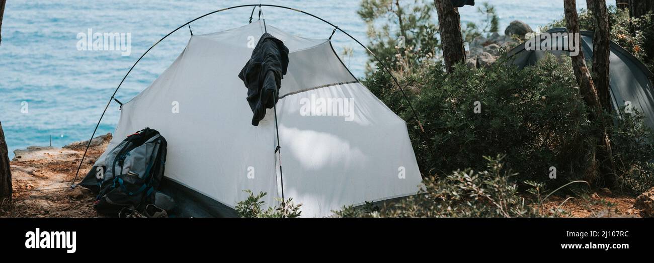 tent vacationing relaxing traveler on the seashore. camping on a trip ...