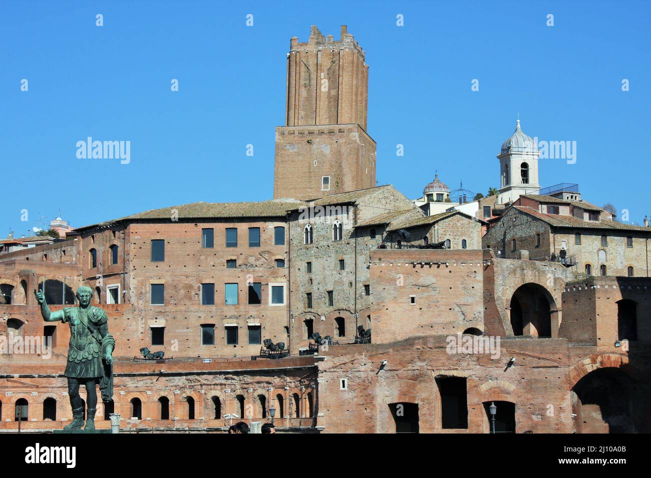 Statue of Roman emperor Julius Caesar Augustus and a building of the ...