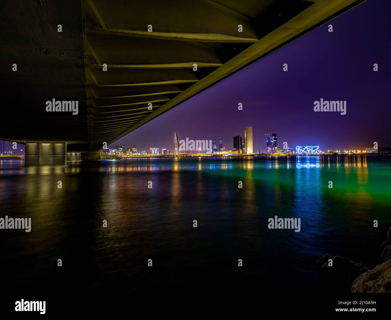 Bridge over the river with skyscrapers in the background in Bahrain ...
