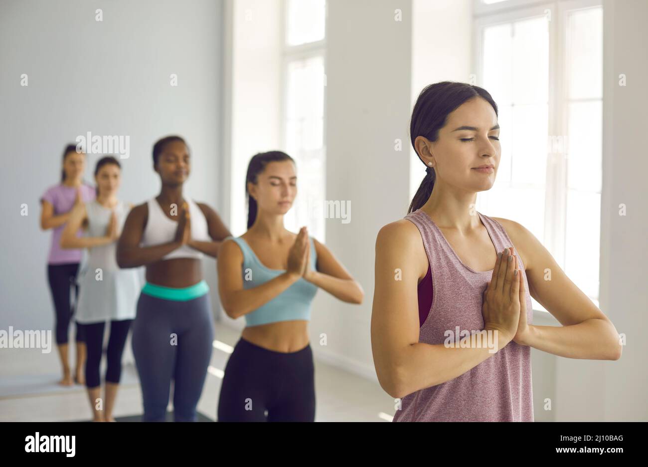 Diverse women train practice yoga together in fitness club Stock Photo ...