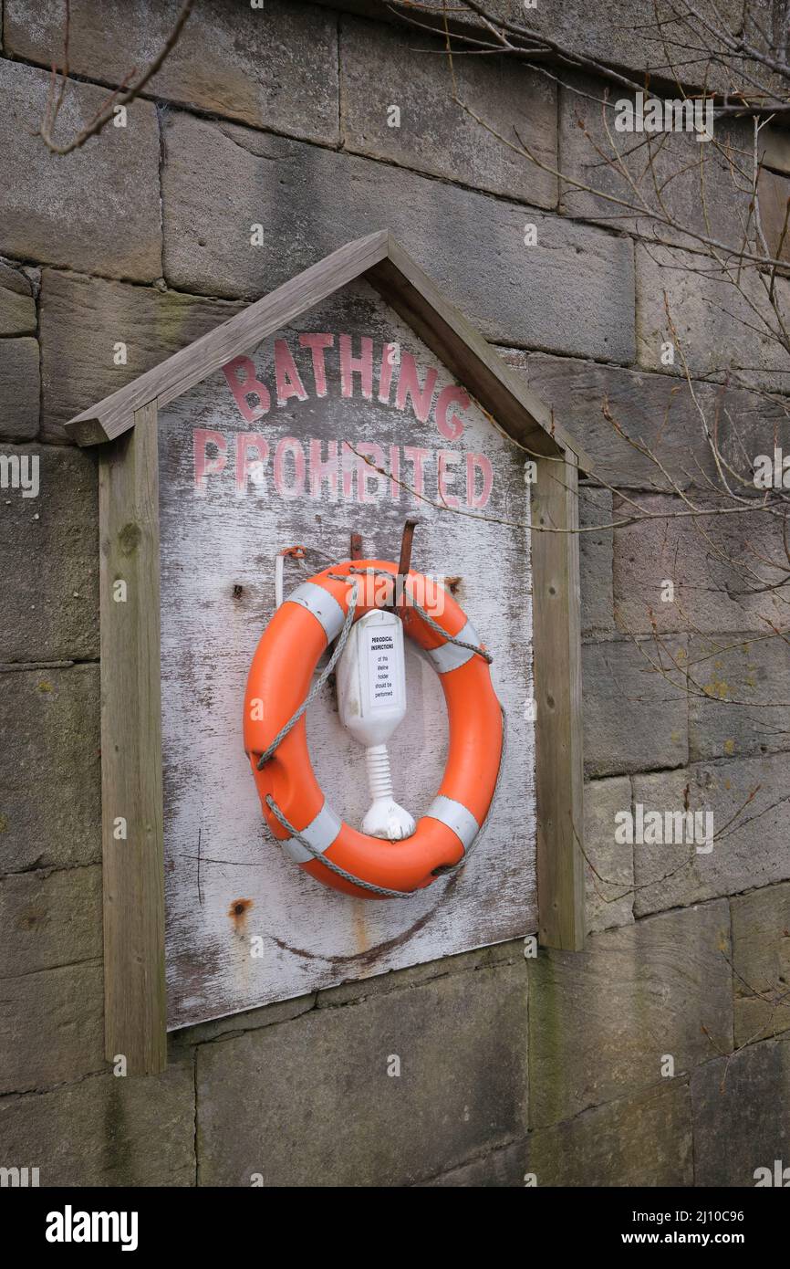 Life belt and bathing prohibited sign on the bridge over the River Ure ...