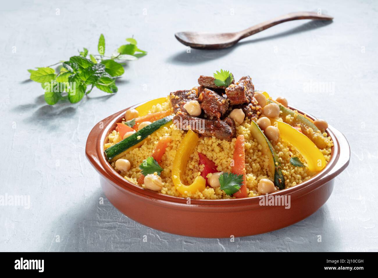 Couscous with meat and vegetables, festive Moroccan dinner, a dish of ...