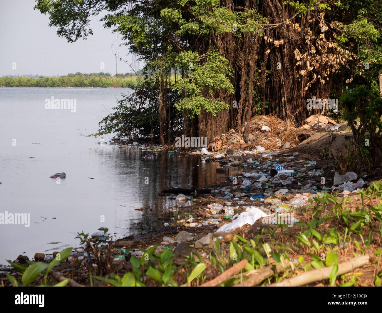 a lot of plastic waste and pollution at a lagoon in West Africa Stock ...