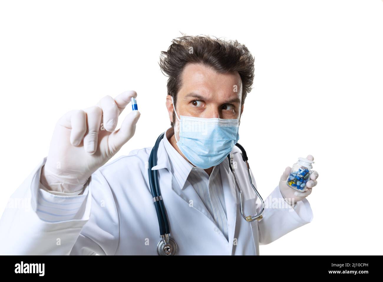 Close-up serious young doctor with stethoscope and face mask on white ...