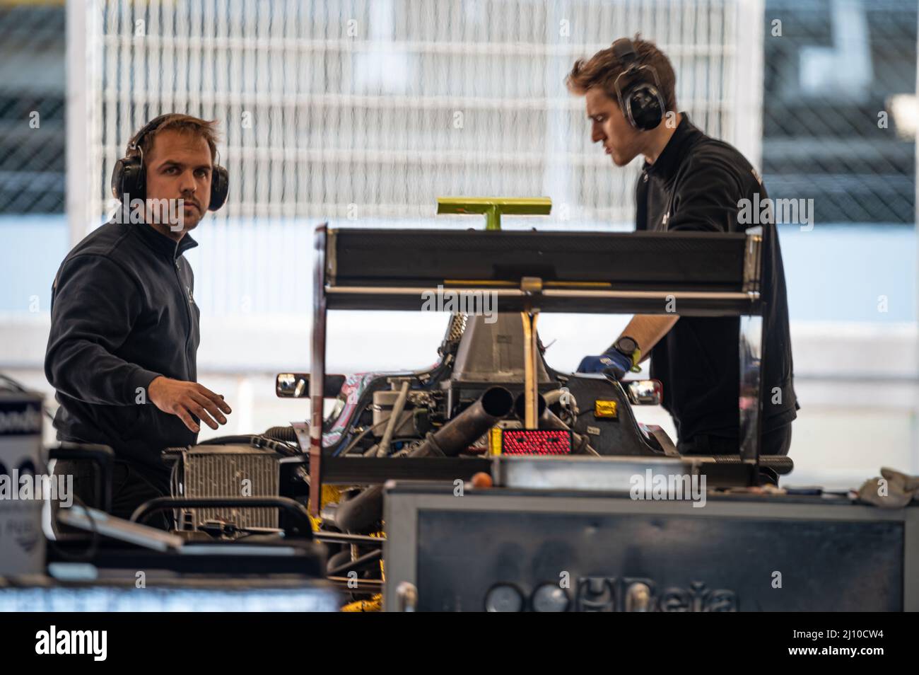 Closeup of Mechanics and track engineers tuning the race car in the ...