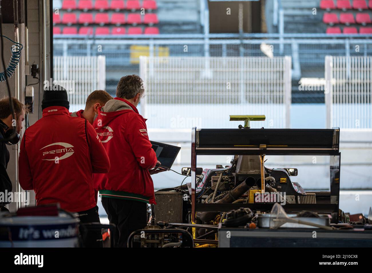 Closeup of the mechanics and engineers tuning the racing car in the ...