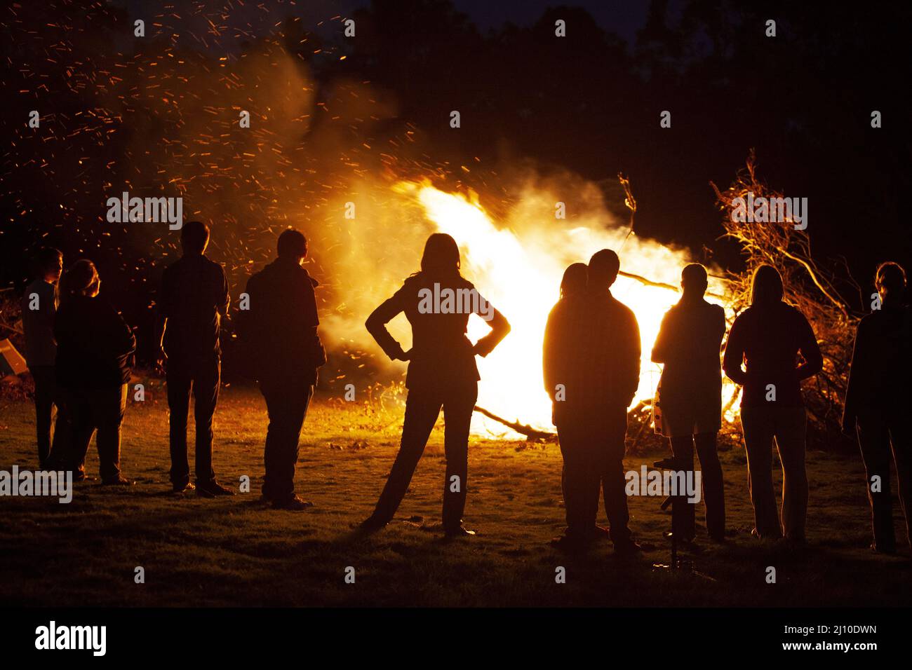 People standing watching a bonfire in the park in the dark night Stock ...