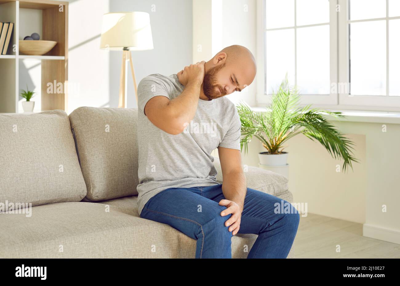 Sick man struggle with acute pain in neck Stock Photo - Alamy