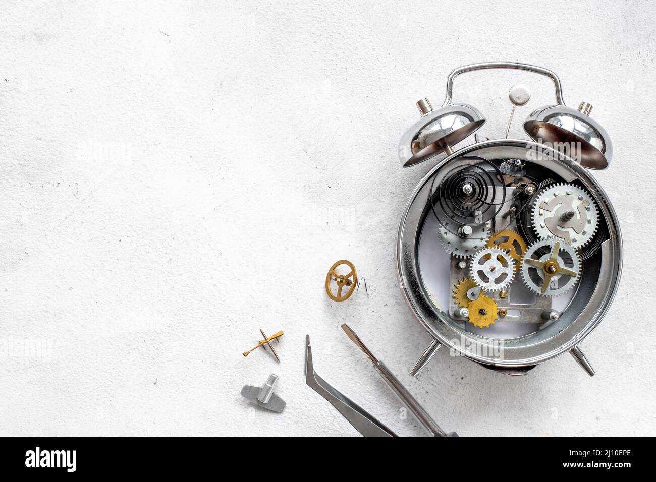 Broken alarm clock top view. Watch mechanism and watchmaker tools Stock ...