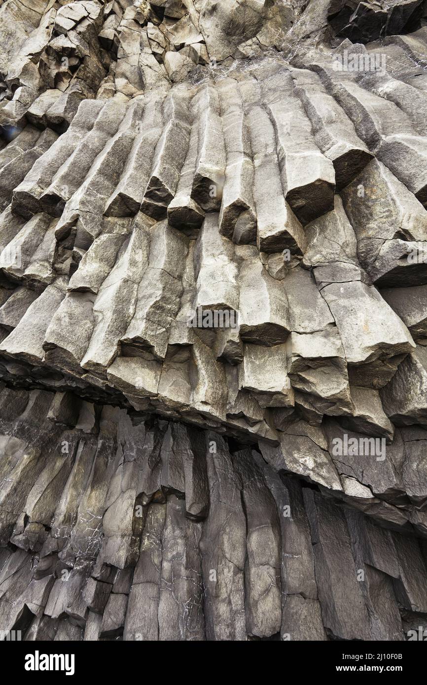 Columns of rocks created from basaltic lava, in coastal cliffs at ...