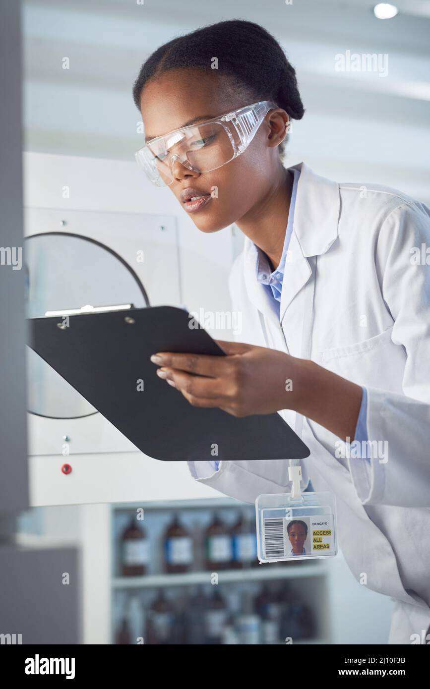 Drawing conclusions from her observations. Shot of a young scientist ...