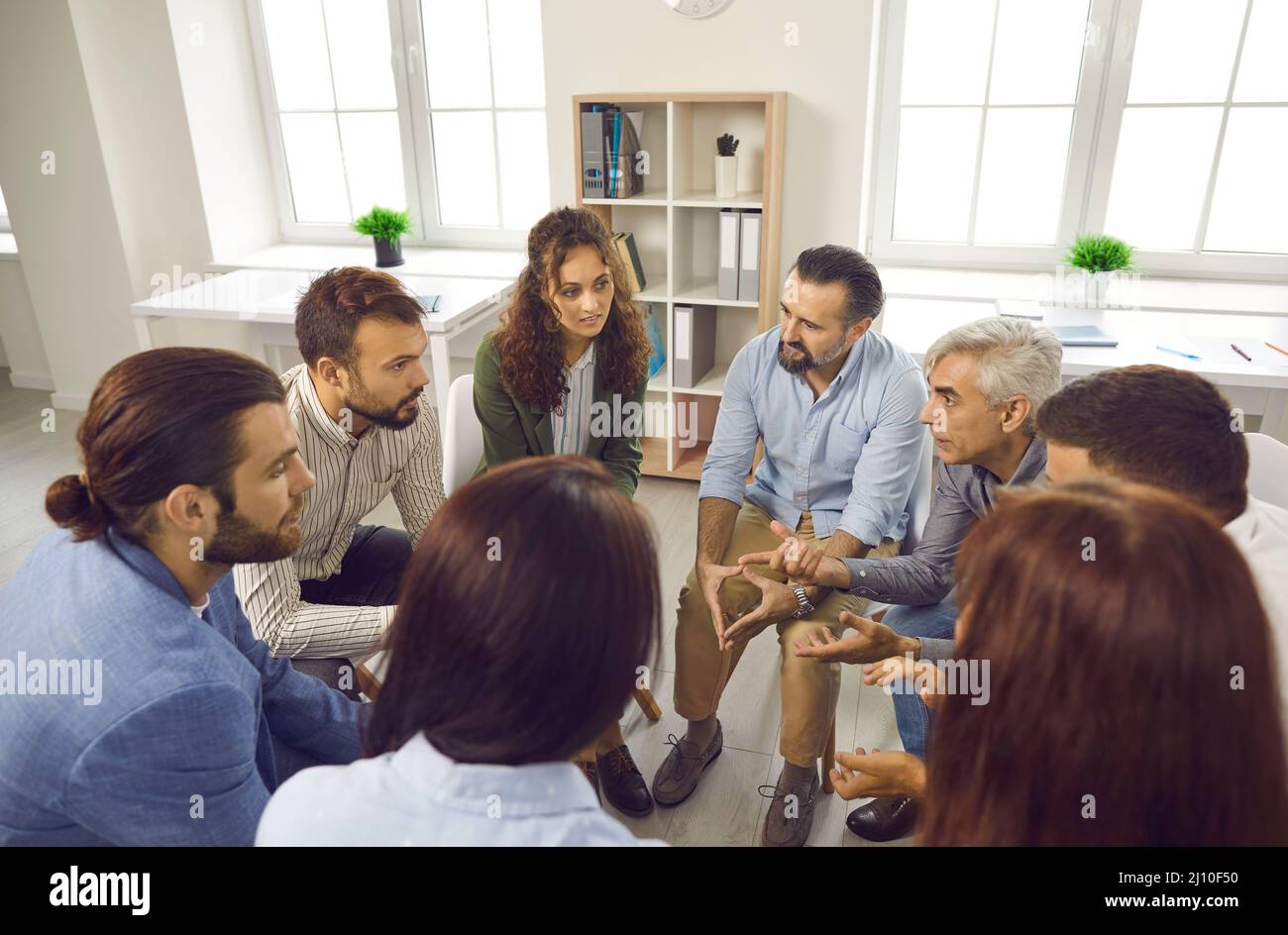 Group of business people having a discussion during a work meeting in ...