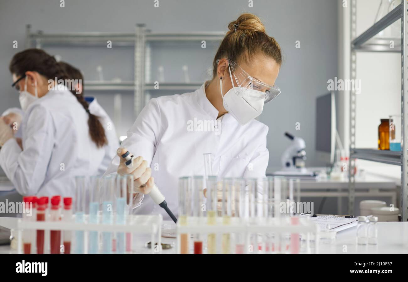 Biotech lab woman mask pipette hi-res stock photography and images - Alamy