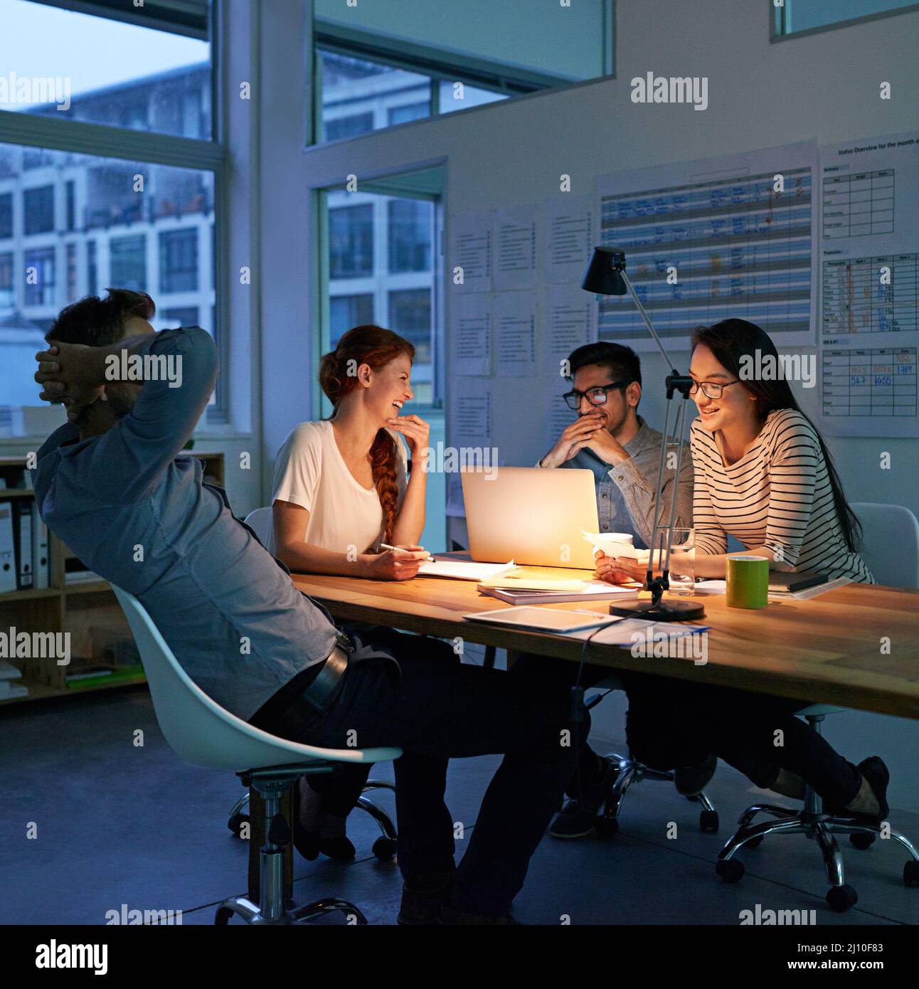 Putting in the work. Cropped shot of four colleagues working into the ...