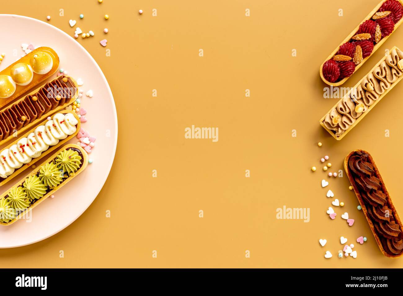 Set of french dessert eclairs with colorful topping Stock Photo - Alamy