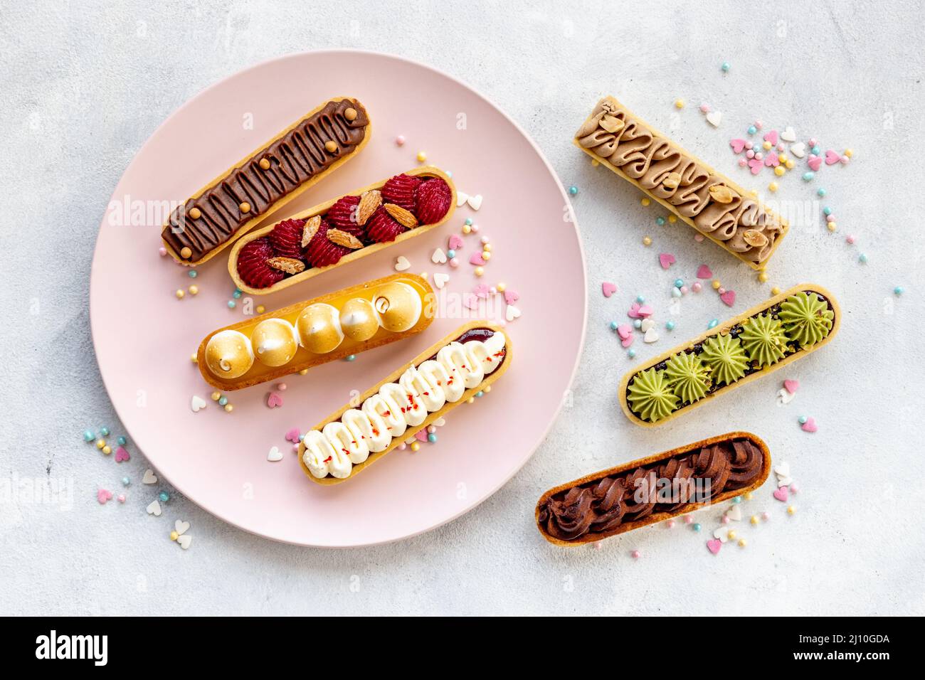 Top view of sweet bakery eclairs with color topping Stock Photo - Alamy