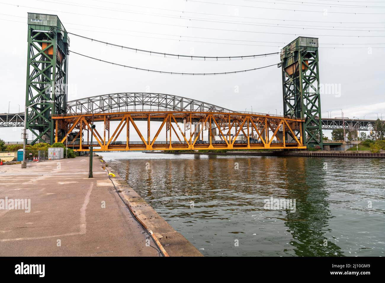 Vertical lift road bridge over a canal leading to a harbour. A Motorway ...