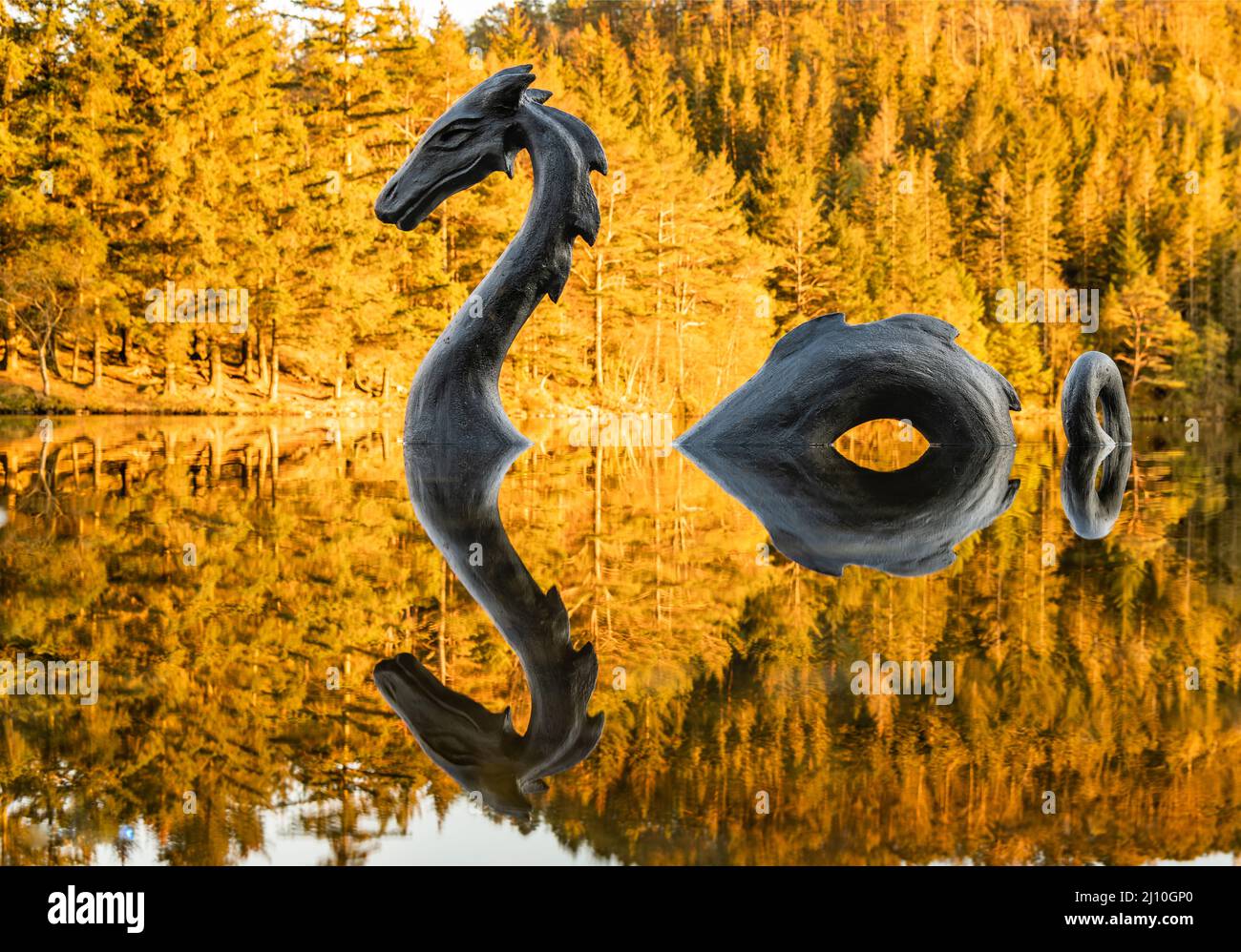 Iron dragon statue in the lake water with bright autumn trees in ...