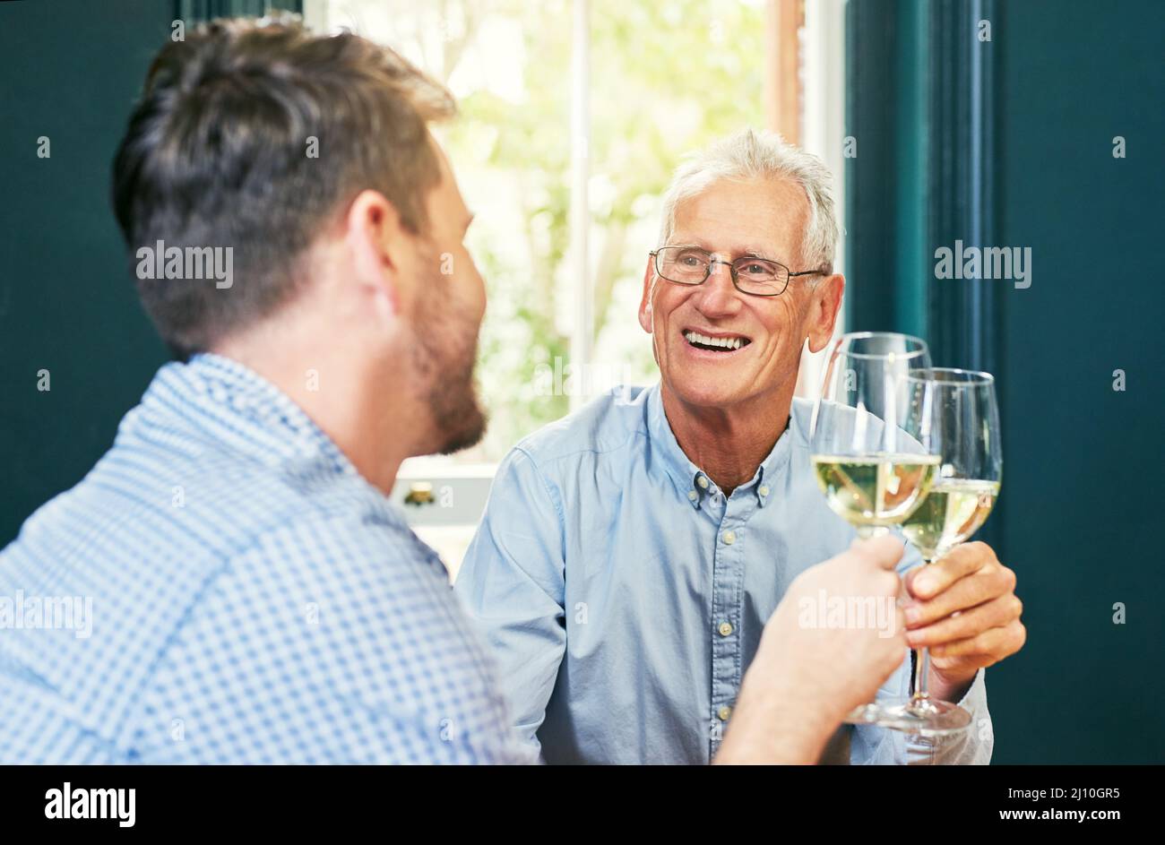 Heres to you and me dad. Shot of a cheerful elderly man and his son ...