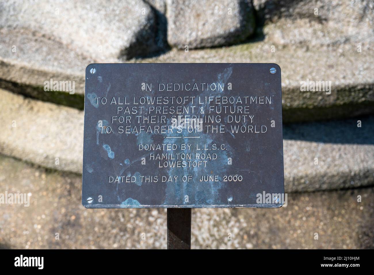 RNLI plaque in front of the sculpture of a RNLI lifeboatman at ...
