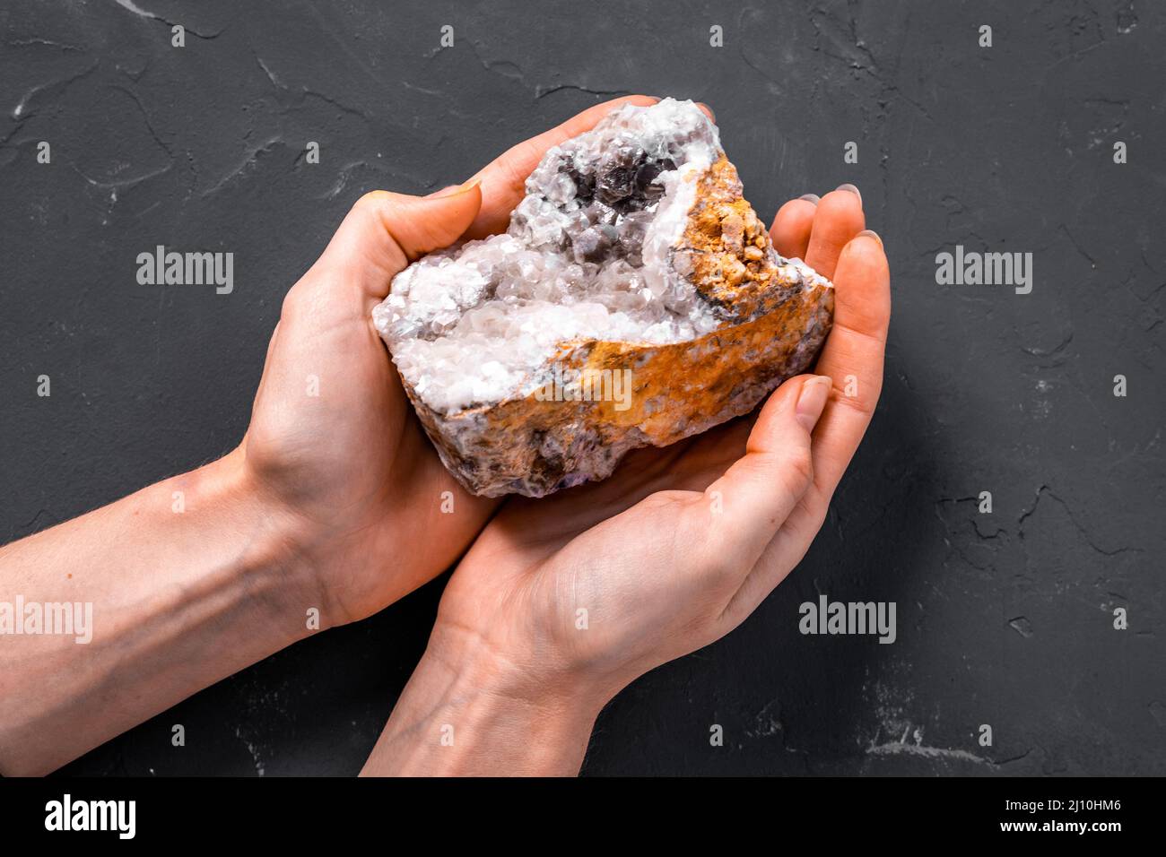 Hands holding natural mineral rock or shiny gemstone Stock Photo - Alamy