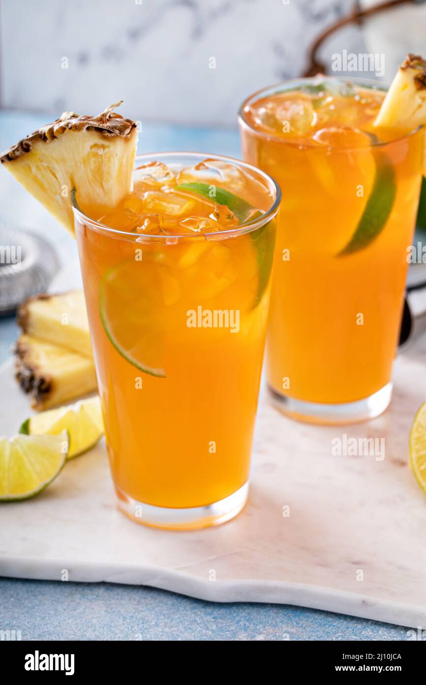 Pineapple rum cocktail with lime slices, refreshing summer cocktail ...