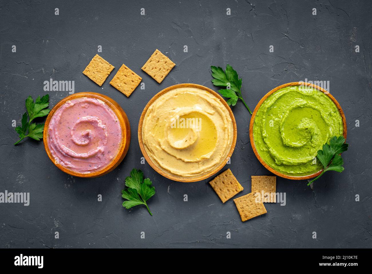 Various types of hummus in bowls. Hummus with spinach and beets Stock ...