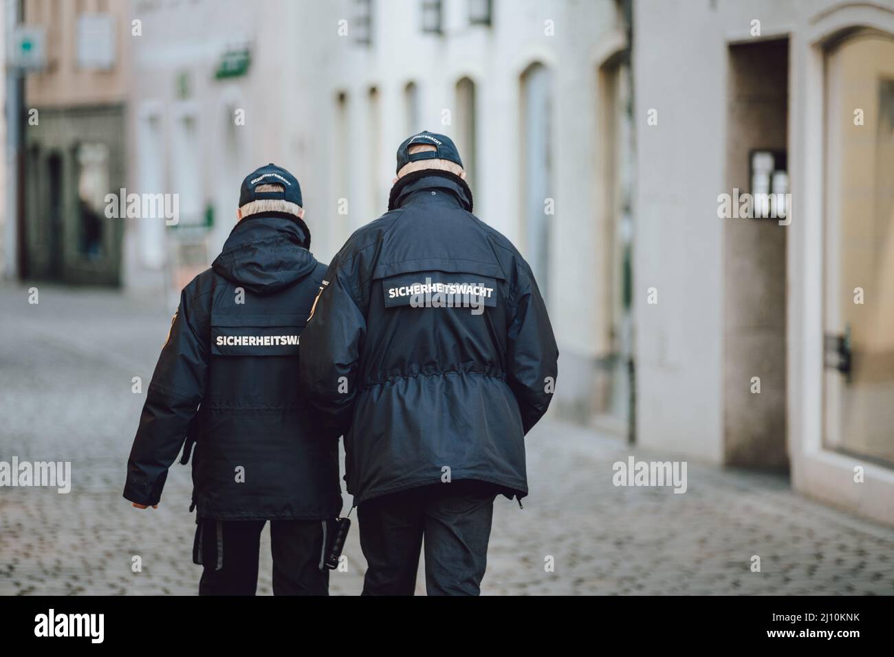 View of security guards walking down the street in the historic center ...
