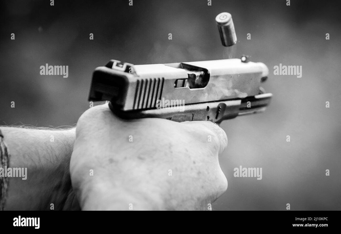 Selective focus of a shooting weapon gun in greyscale Stock Photo - Alamy