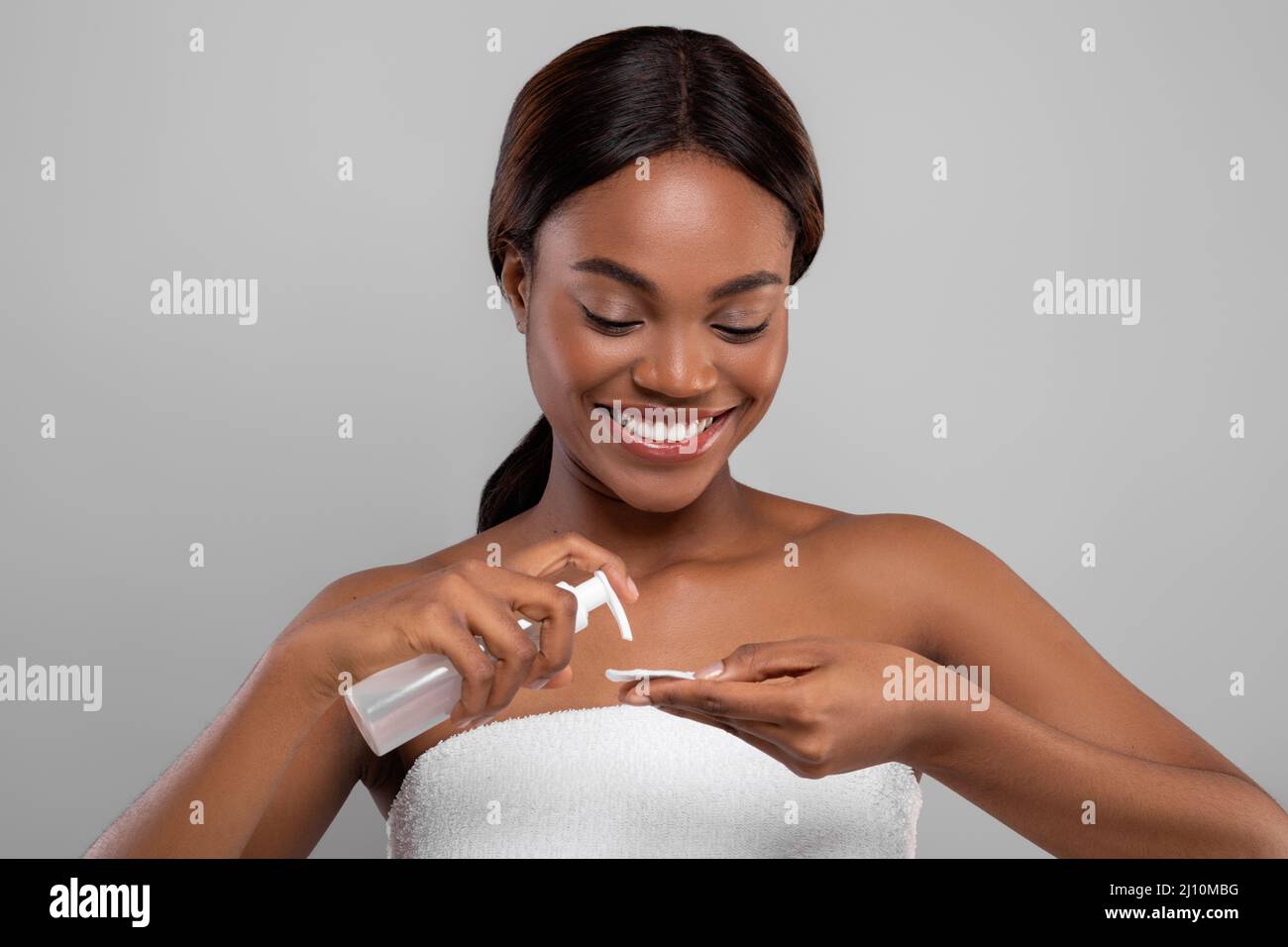Beautiful Black Female Applying Hydrophilic Oil On Cotton Pad For Face ...