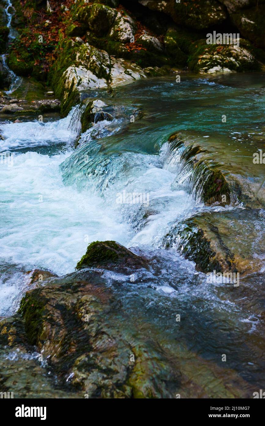 small waterfall on a river with blue clean water in a wild forest Stock ...
