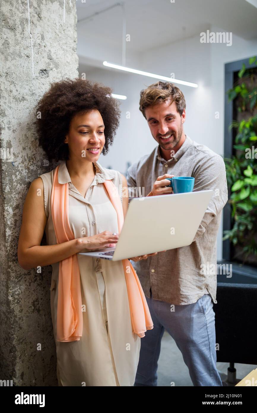 Happy business people having fun and chatting at workplace office ...