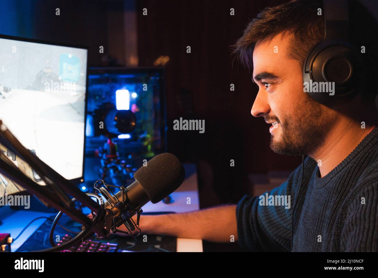 Caucasian gamer with headphones playing in his dark room Stock Photo ...