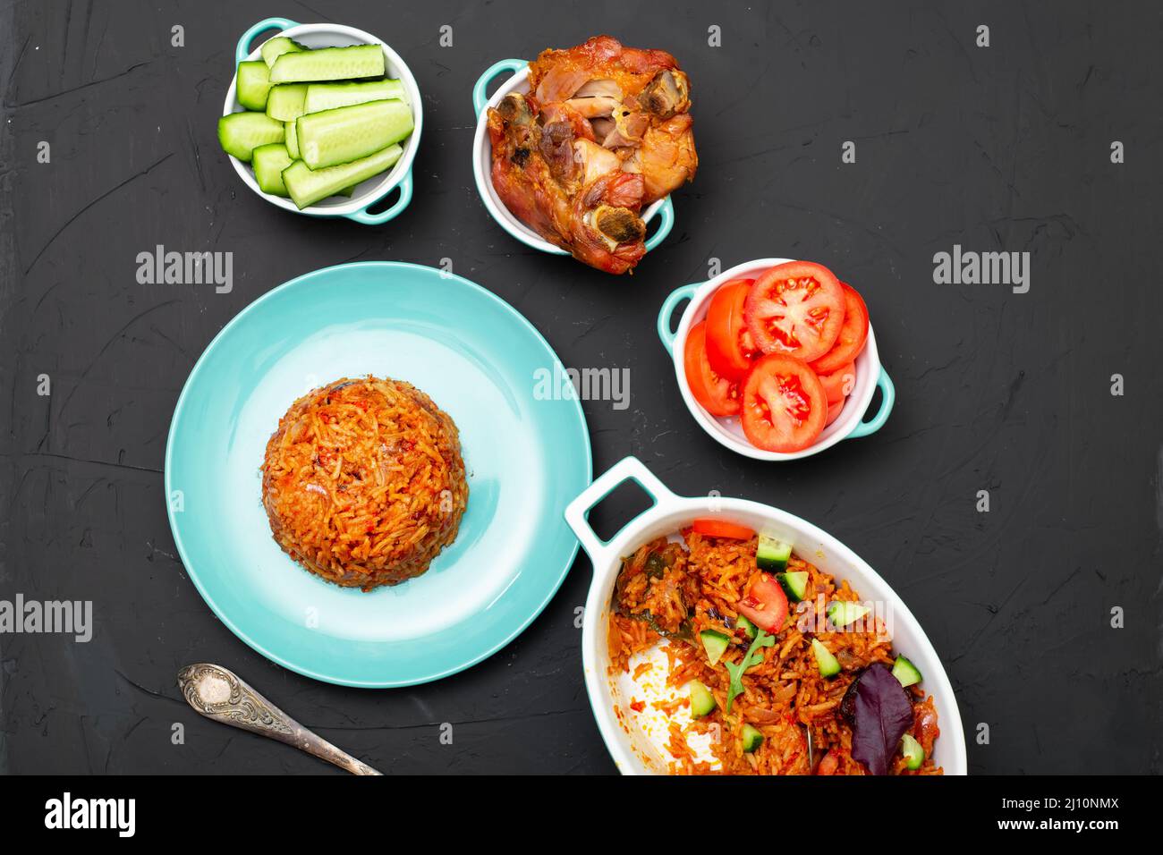 Jollof rice on a plate. Rice with tomatoes, onions, spices. Traditional ...