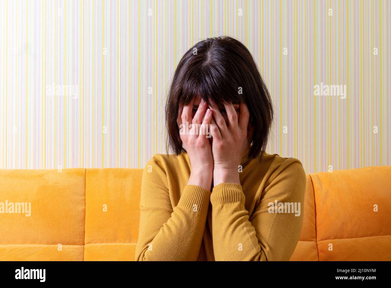 Upset crying middle aged woman suffering from stress covering her face ...