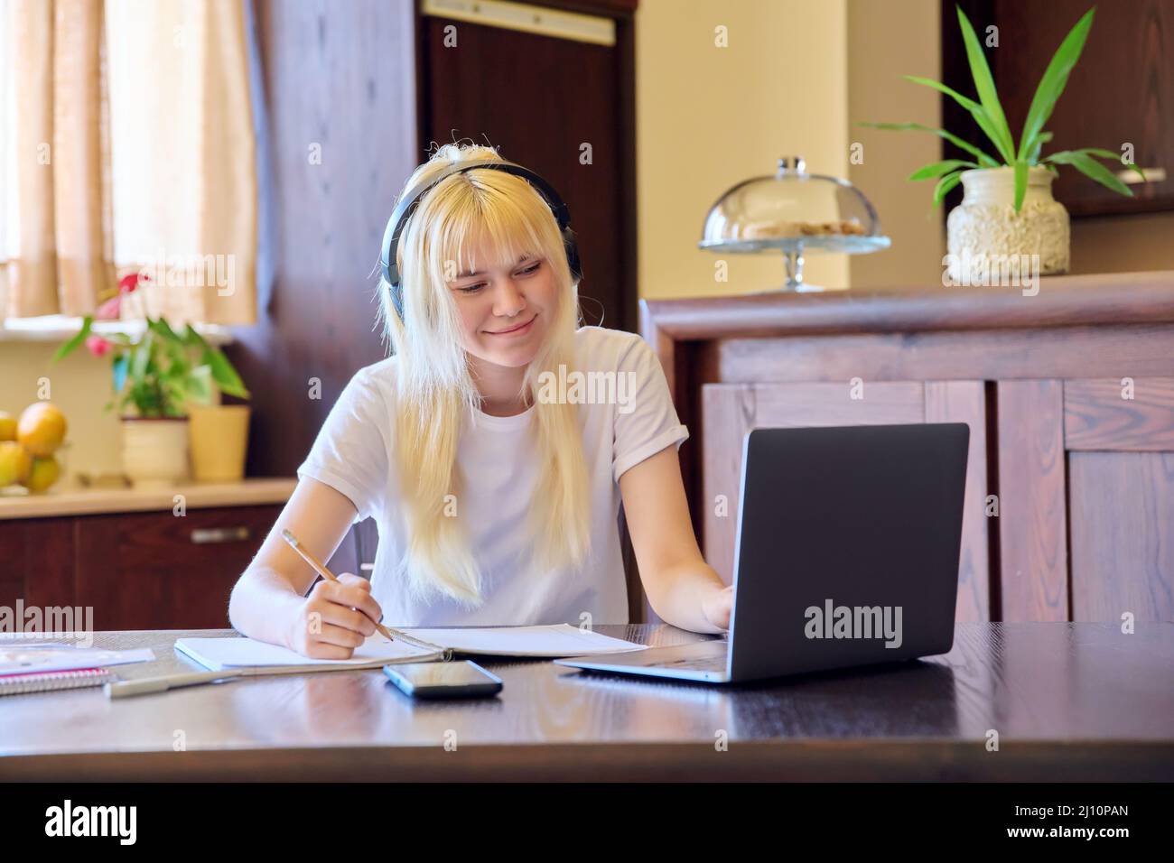 Teenage female student studying at home using a laptop Stock Photo - Alamy