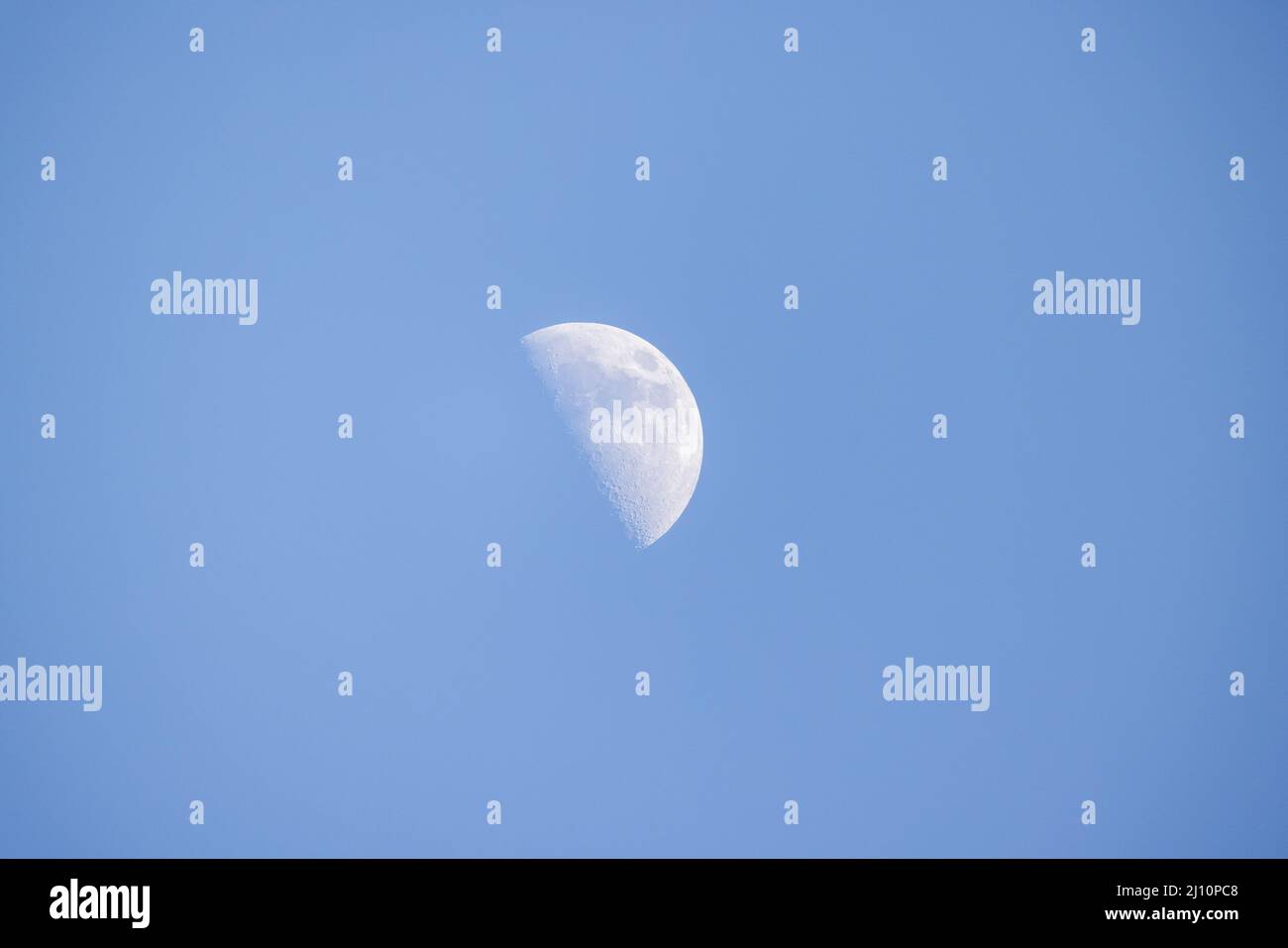 Half moon or waning moon with blue sky. The majestic moon, clear sky ...